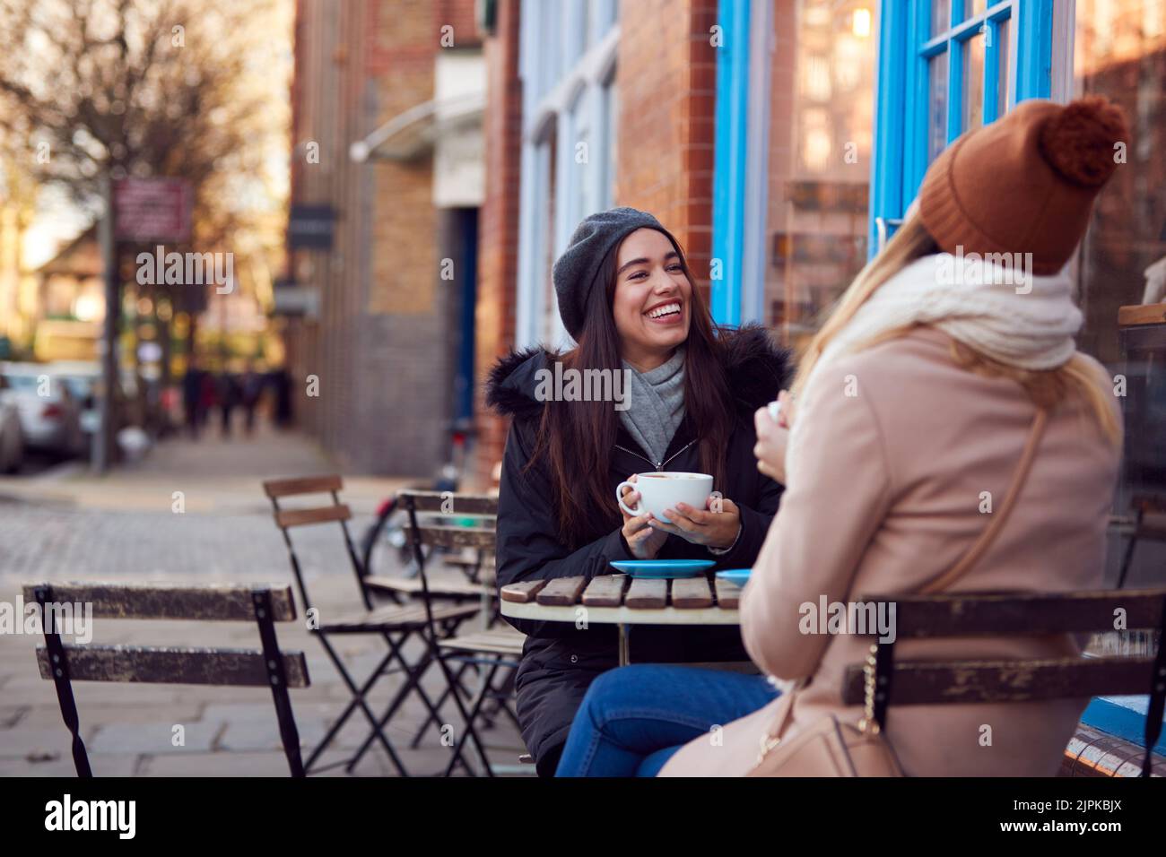 2 female friends laughing cafe hi-res stock photography and images - Alamy