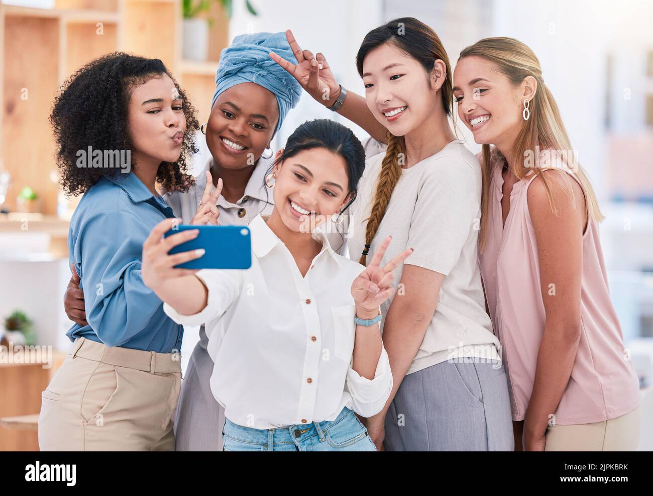 Fun, diverse and playful team selfie on phone and having fun, goofing ...