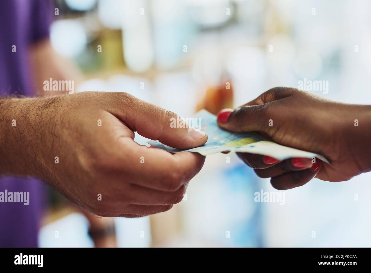 Keep the change. an unrecognizable customer making payment in a store ...