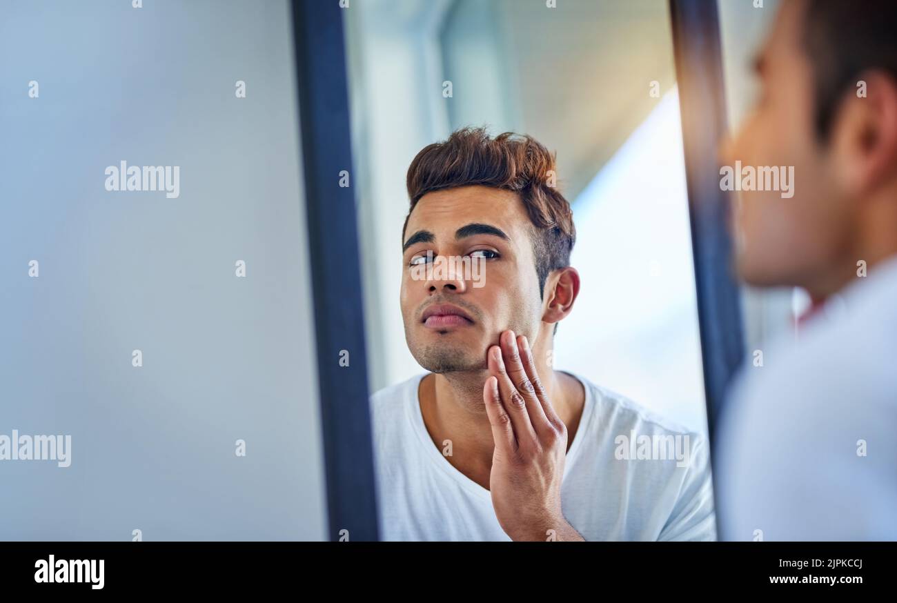 You dont get smoother than that. a handsome young man admiring looking ...