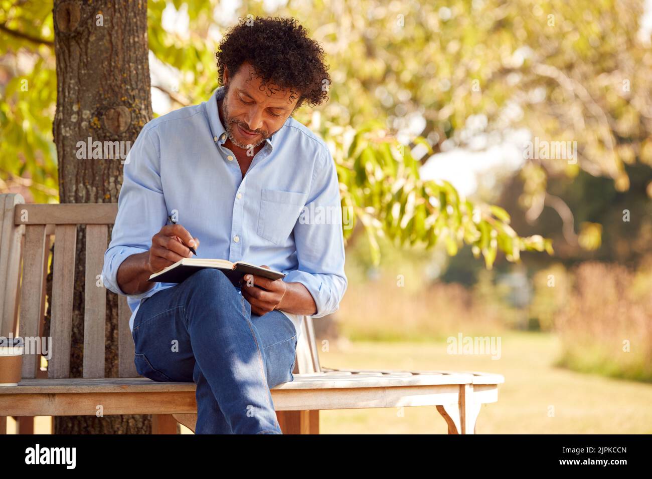 Man writing diary outside hi-res stock photography and images - Alamy