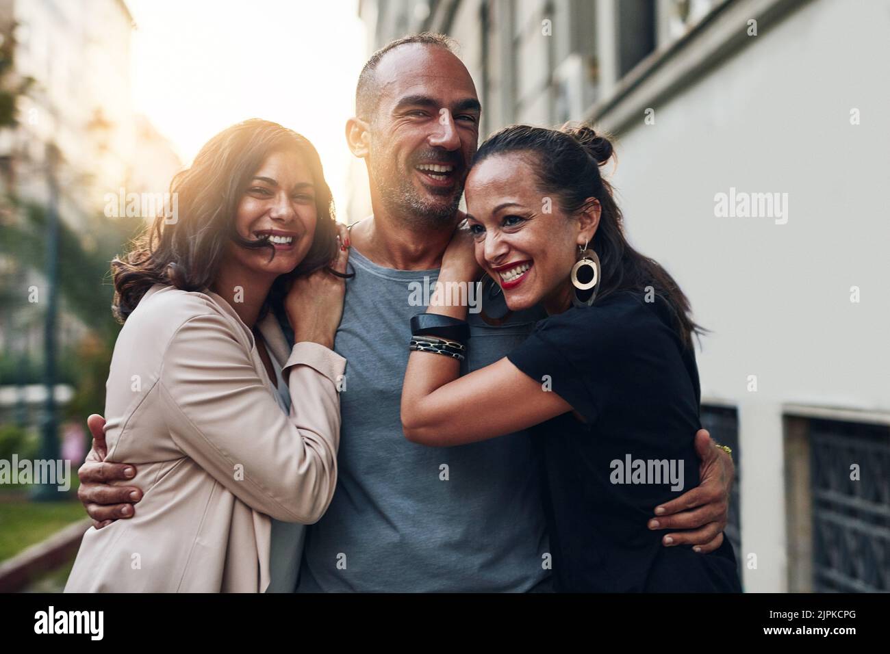 Friends are everything. three friends having fun while out in the city ...