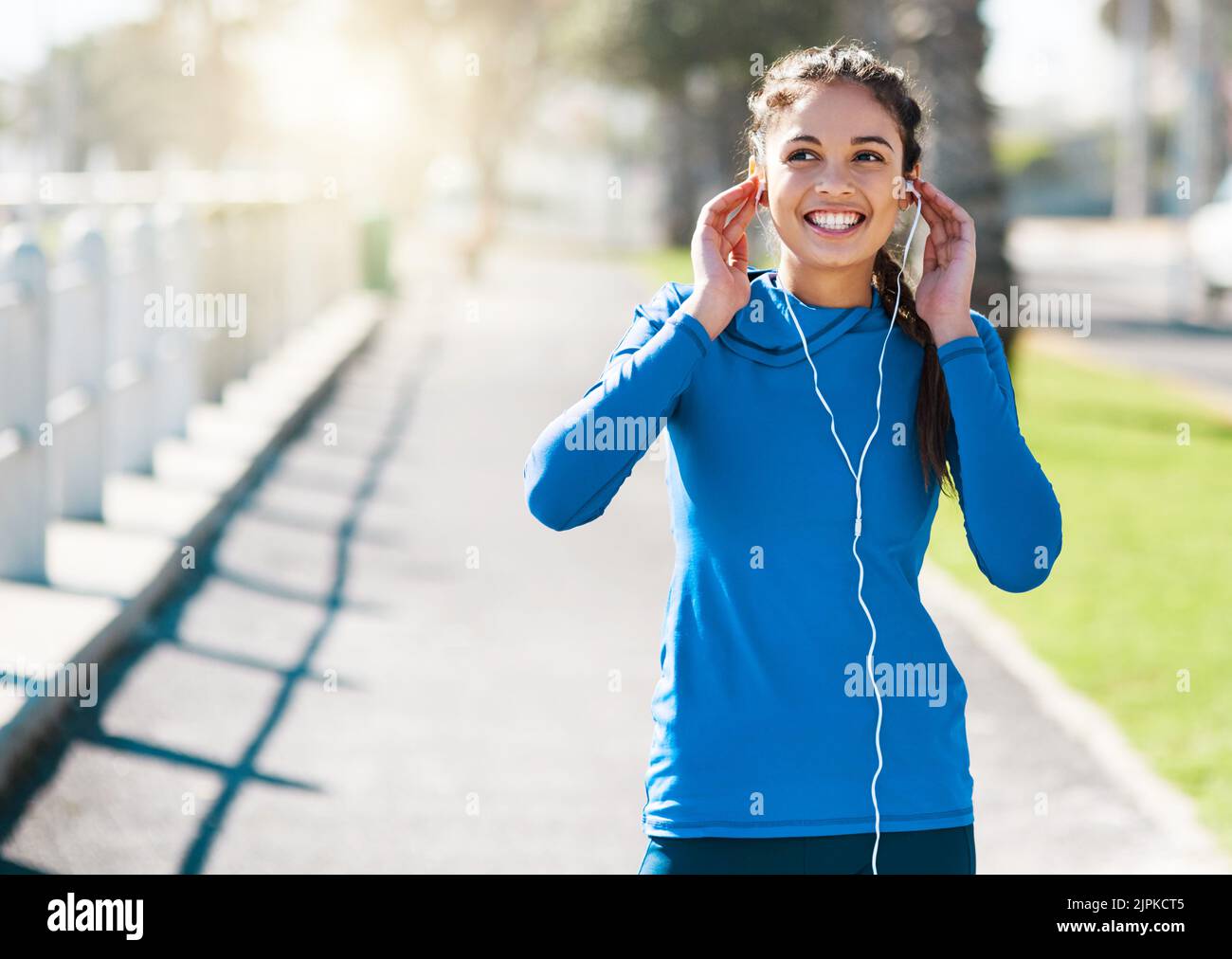 Get your workout groove on. a sporty young woman listening to music ...