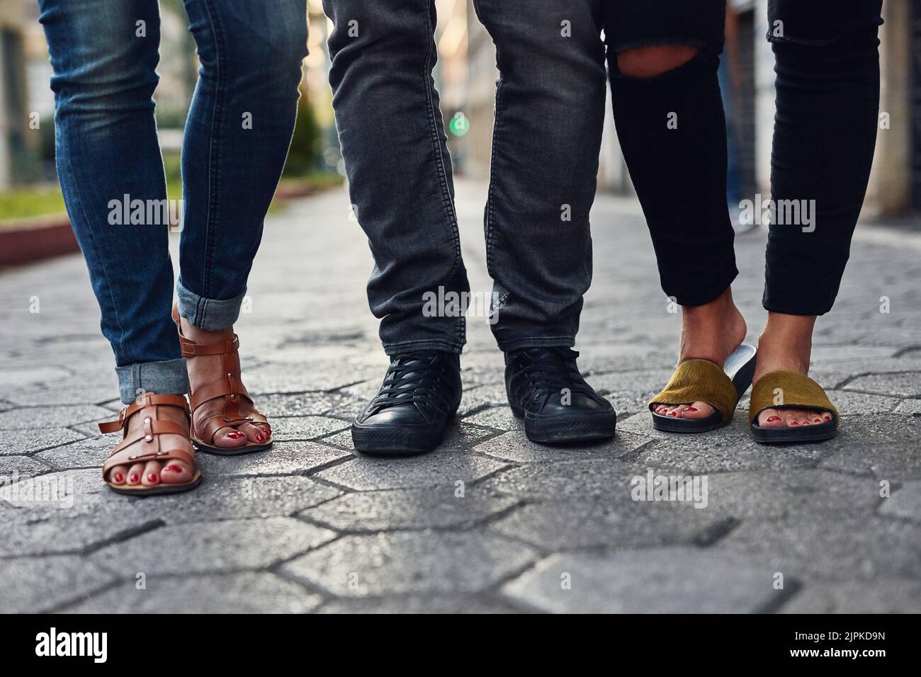 They walk these streets together. three people walking together in the ...