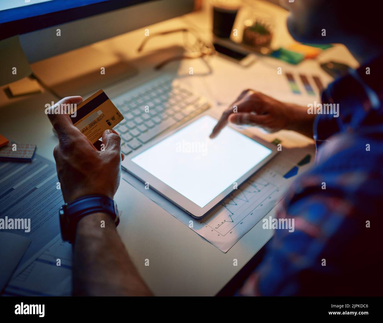 Late night payments online. an unrecognizable businessman using a ...