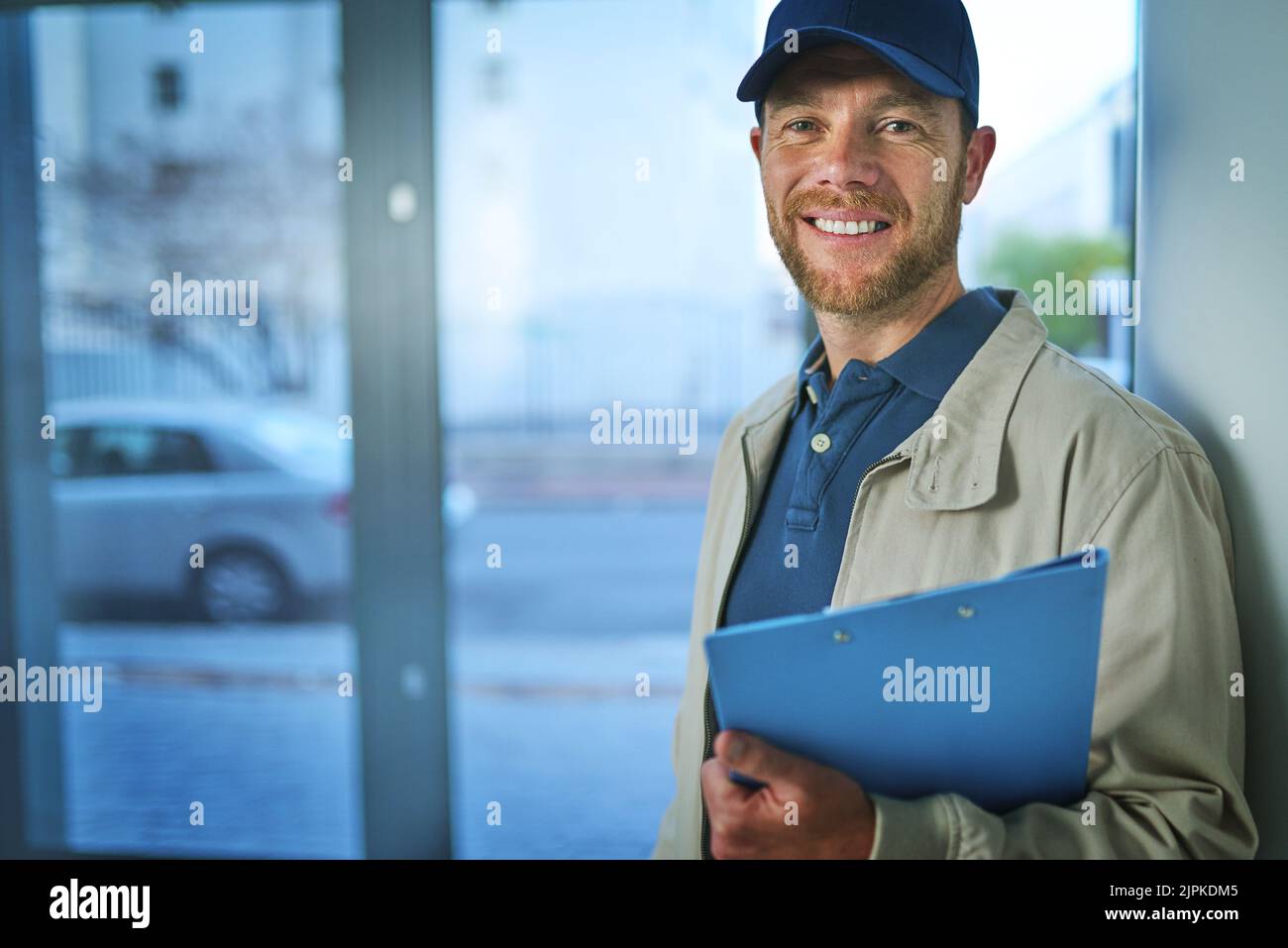 Delivery man reporting for duty. a young man making a home delivery ...