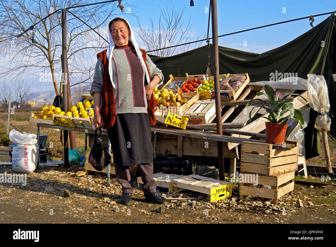 Old lady selling fruit and vegetables at rural market stall, Albania ...