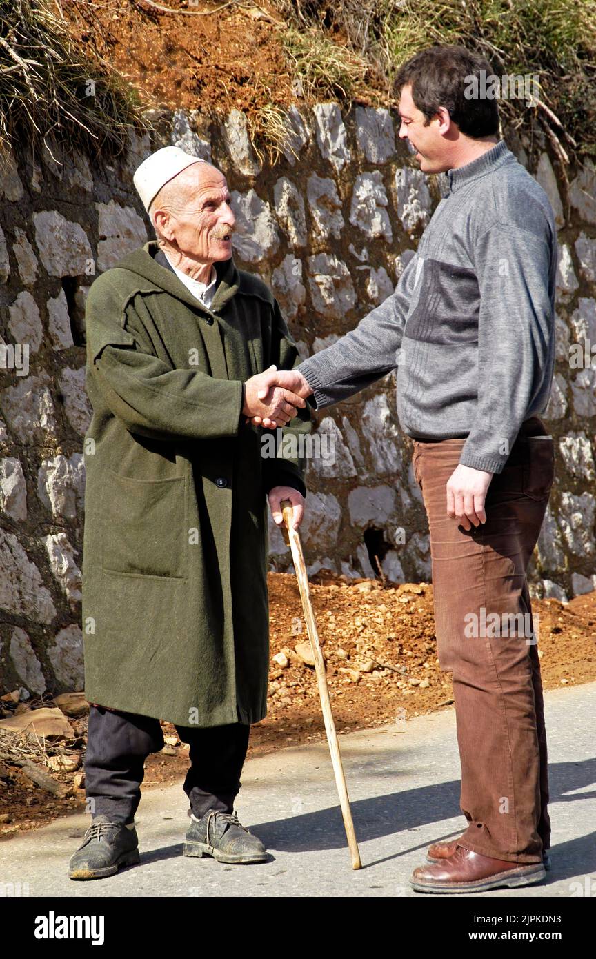Albanian peasant farmer greeting young man, rural Albania Stock Photo ...