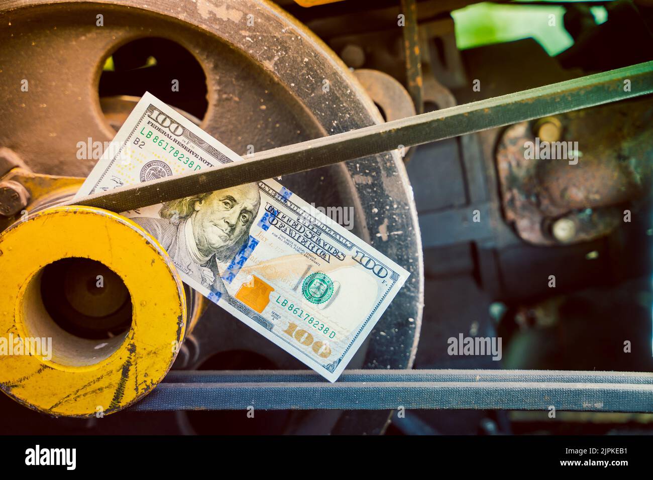 One hundred dollar bill close-up against the background of the engine ...