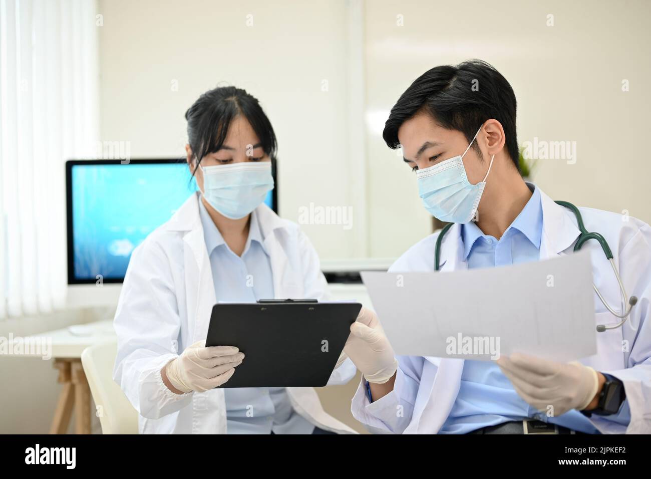 Professional Asian male doctor medical supervisor giving a medical ...