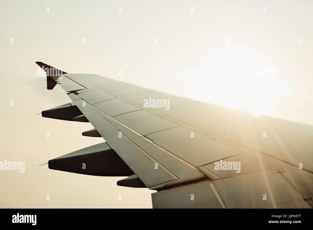 Have a safe trip. an airplanes wing in mid flight Stock Photo - Alamy