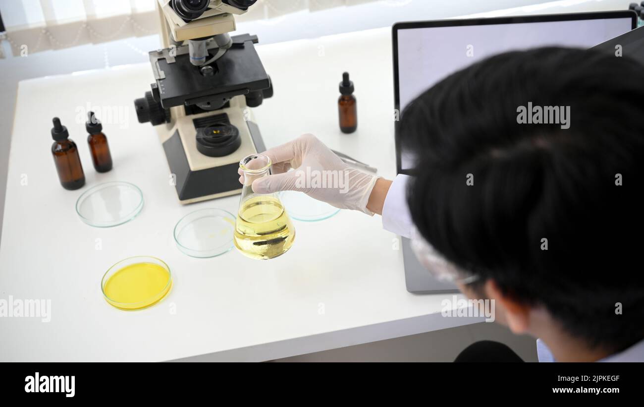 A specialist Asian male scientist or medical researcher adjust a ...