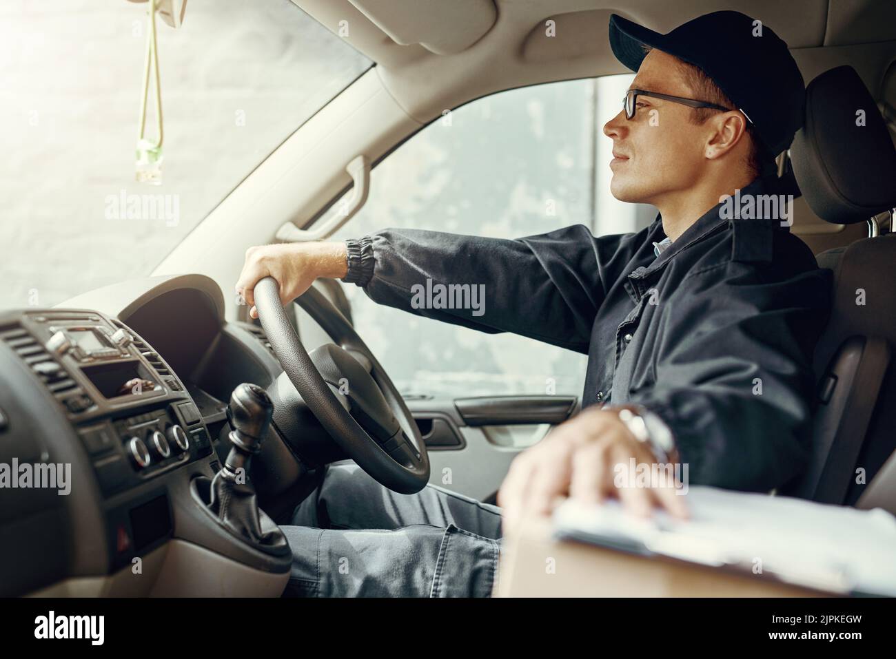 Making his delivery stops. a courier making deliveries in his van Stock ...