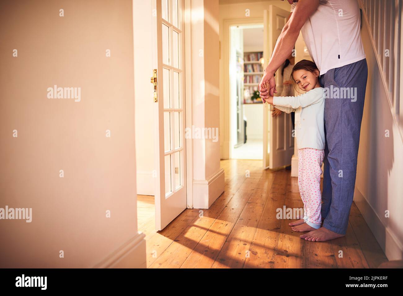 I want to be as big as daddy. Portrait of a cheerful little girl ...
