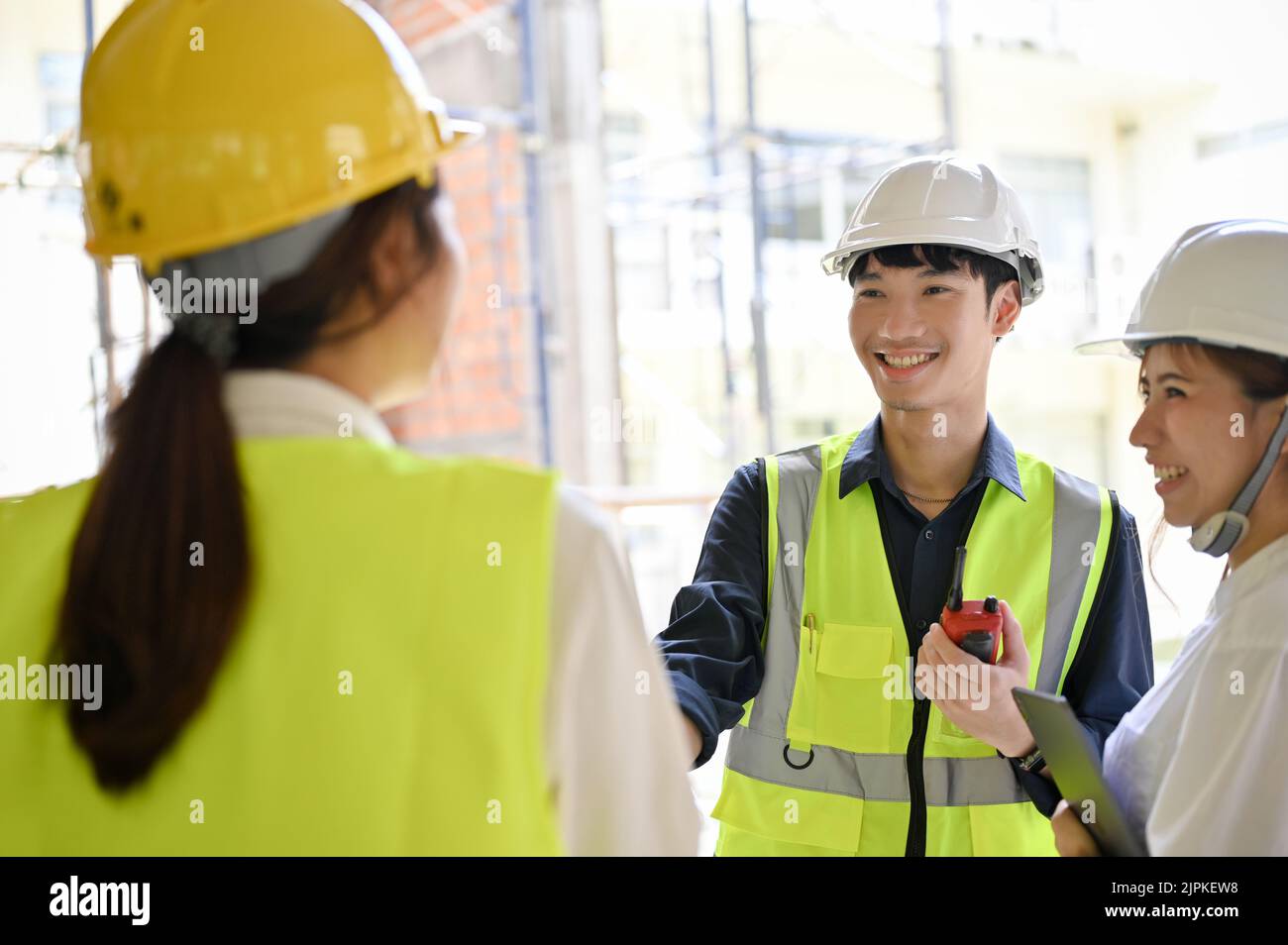 Happy and cheerful young Asian male civil engineer having a great ...