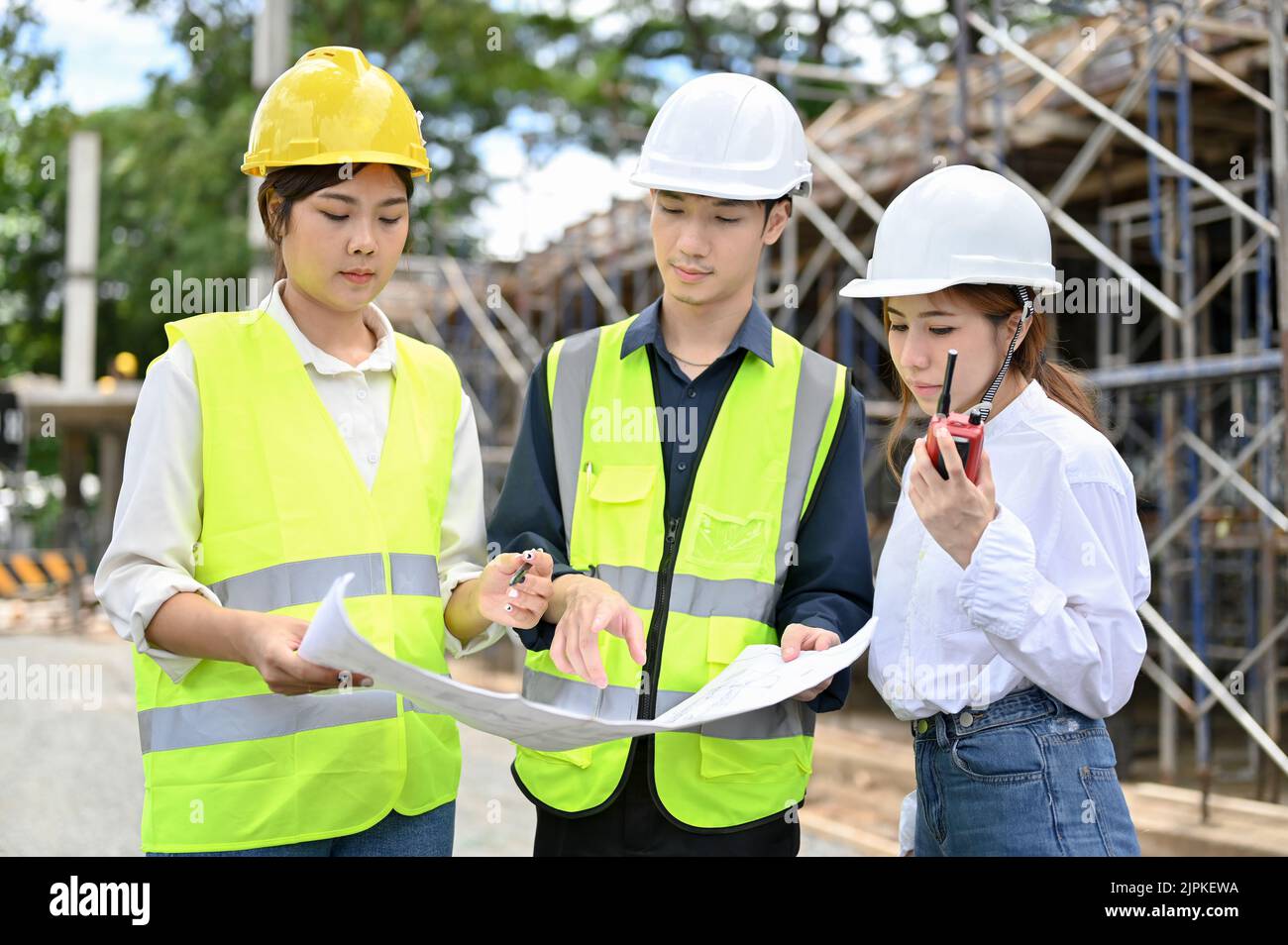 Two talented young Asian female and male architects working and ...
