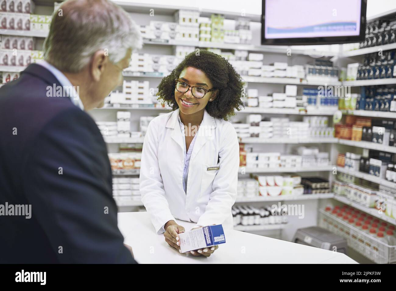 I found what you need. a cheerful young female pharmacist giving a ...