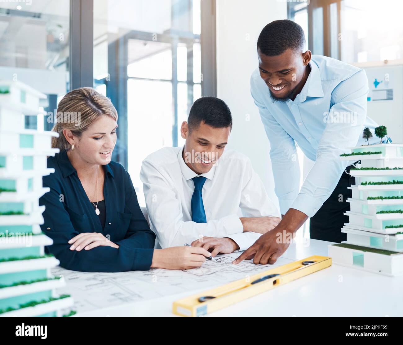 Design, architecture and diversity of a team of architects working on construction blueprint ...