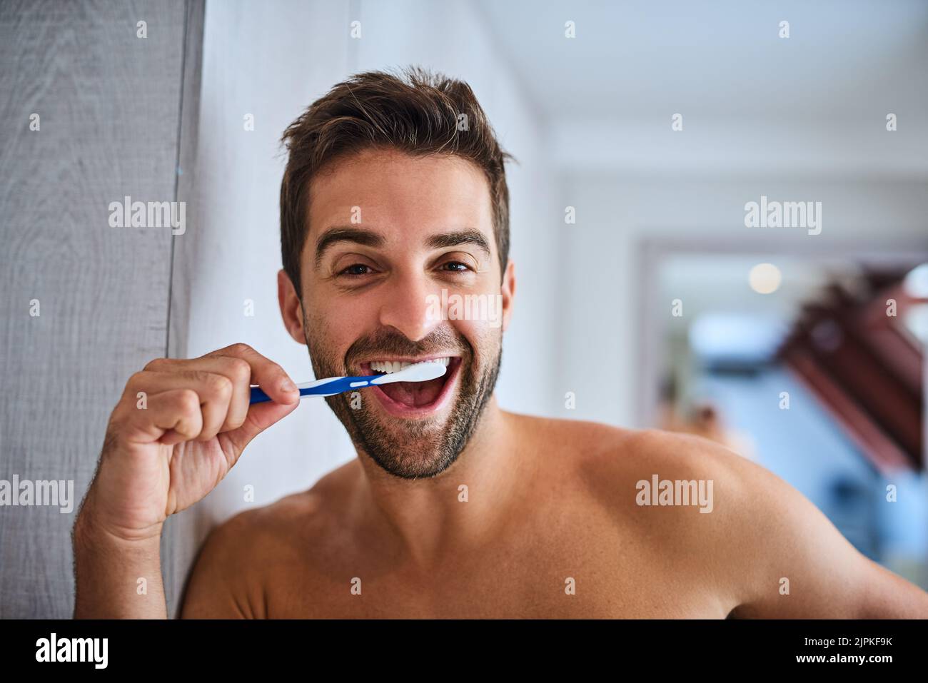 Fresh breath for a fresh day. a handsome young man brushing his teeth ...