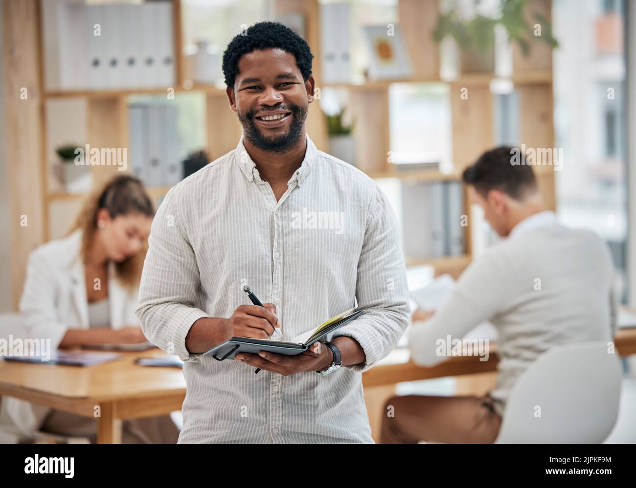 Business man planning ideas in book, writing notes and planning his ...