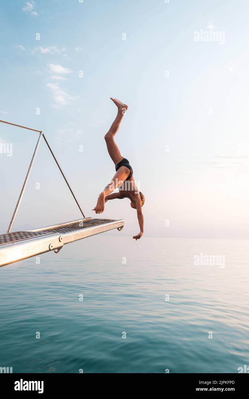Kid diving from yacht into the sea, summertime fun Stock Photo - Alamy