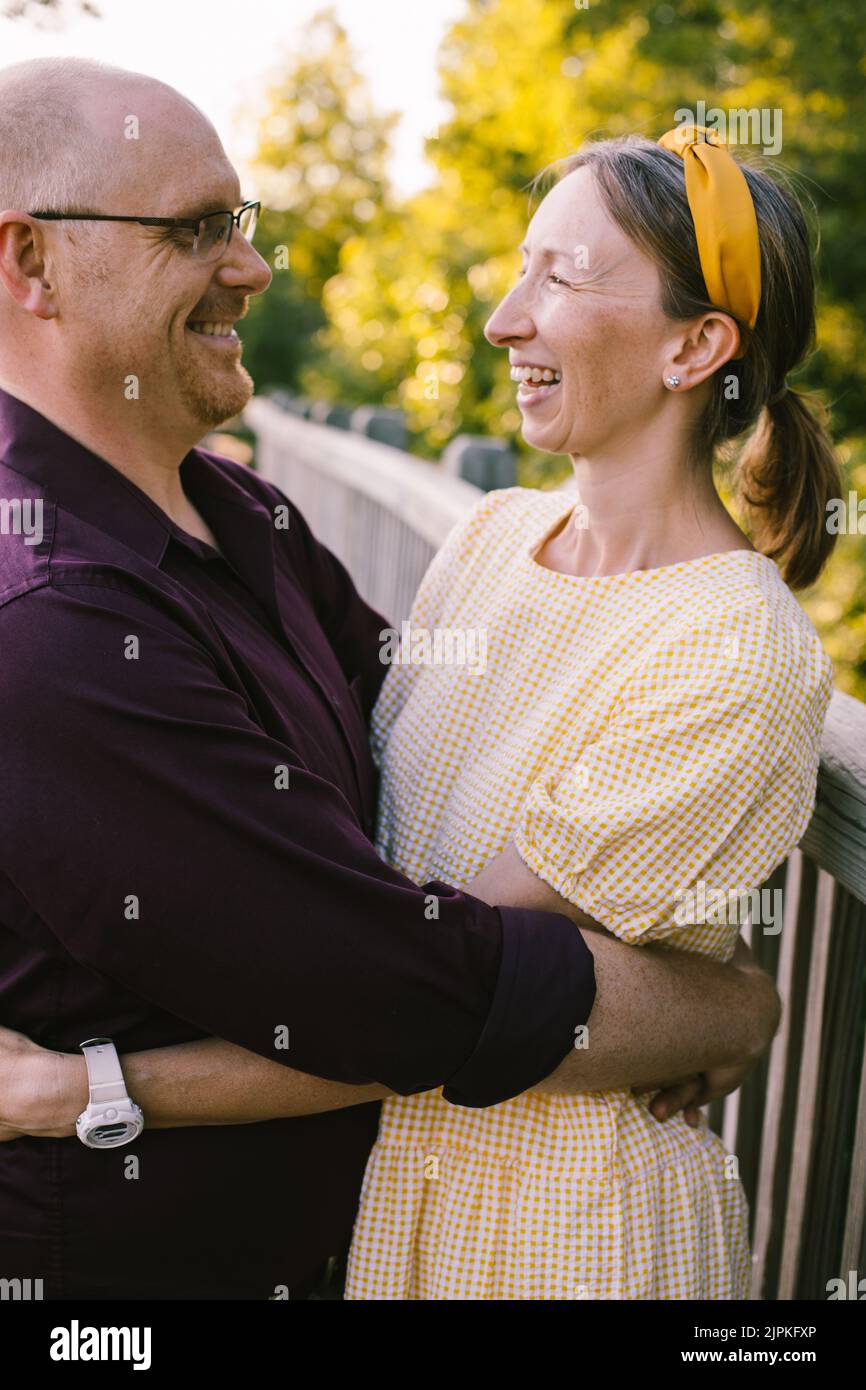 Husband and wife hug together and smile at each other Stock Photo - Alamy