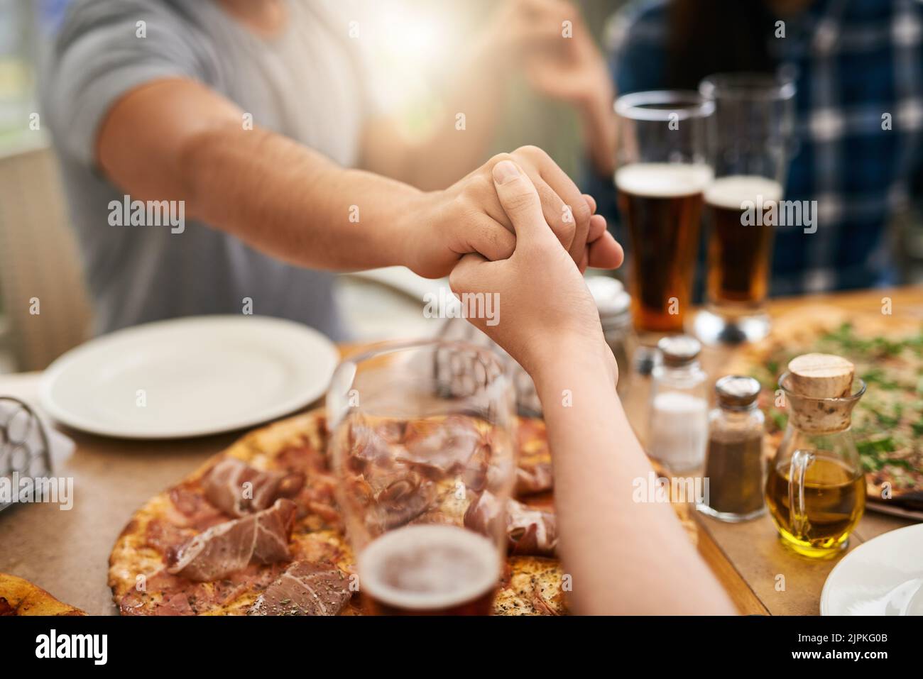 Whos saying grace this time. two unrecognizable people holding hands to ...