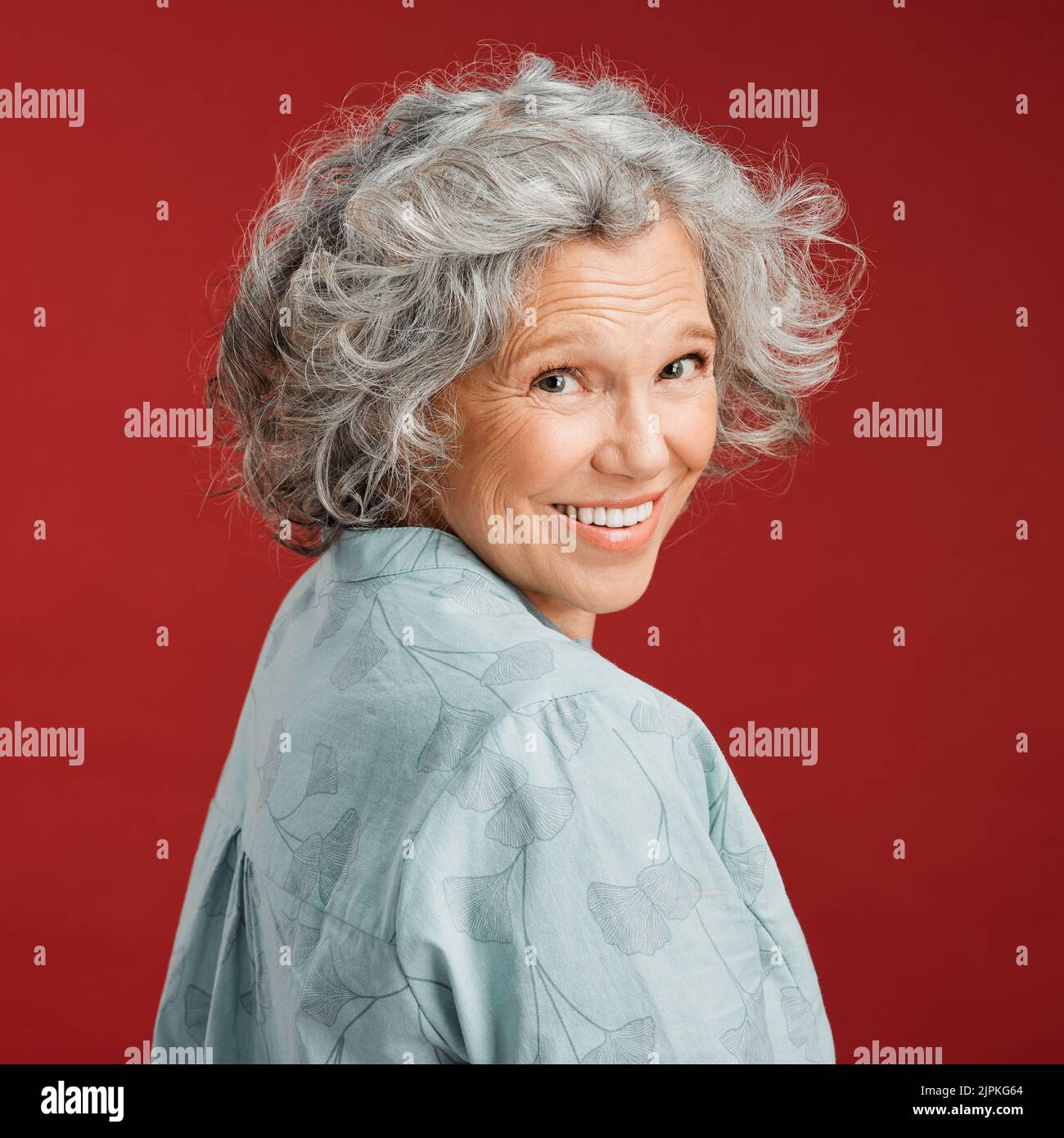 .. Confident, happy and smiling senior woman feeling playful and cheerful while posing against ...