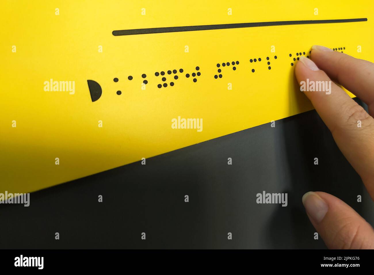 Woman hand reading braille text Stock Photo - Alamy