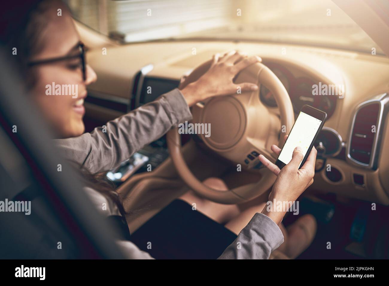 Navigating her way to success. a young businesswoman using a cellphone ...