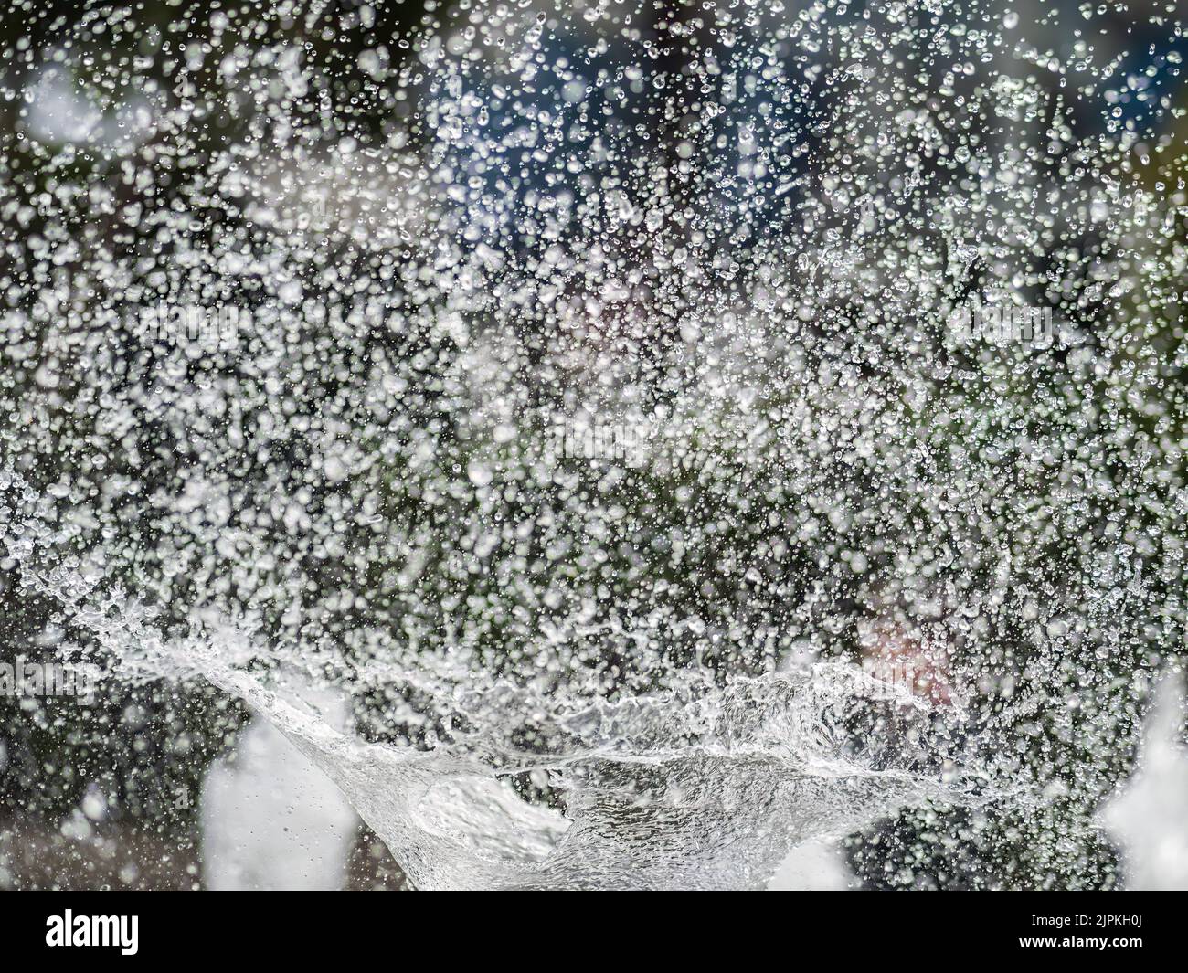 Water splashes from fountain on dark background. Natural texture of ...