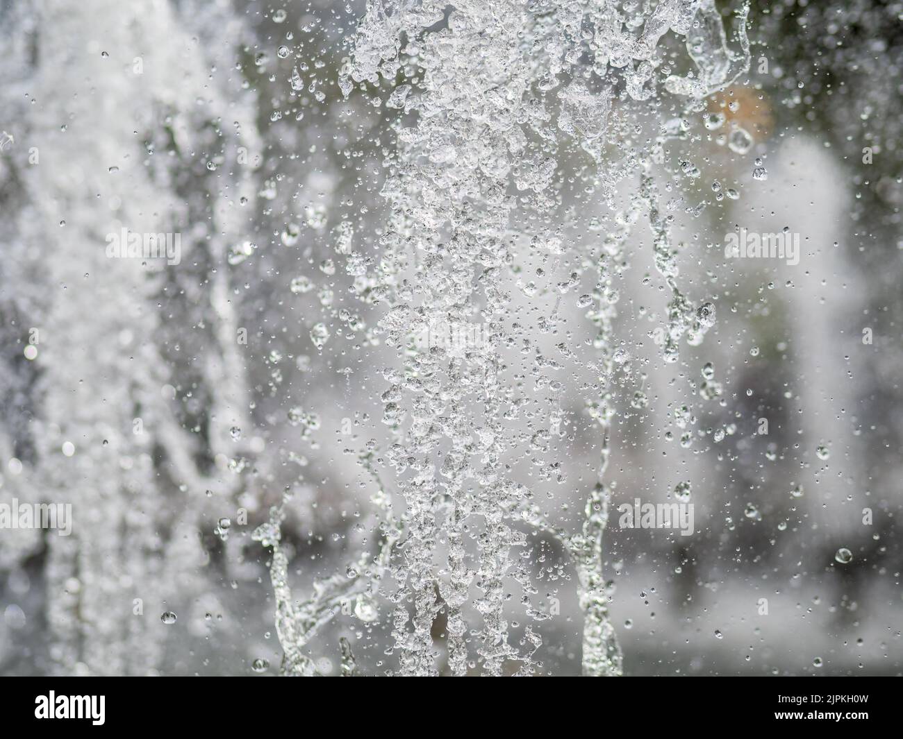 Water splashes from fountain on dark background. Natural texture of ...