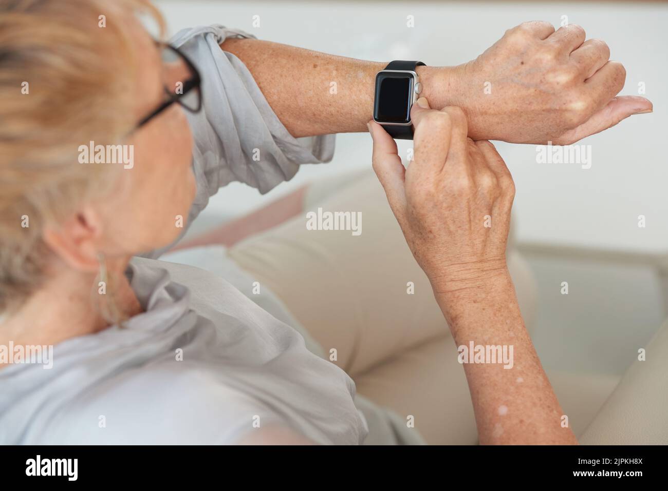 Senior woman checking smartwatch hi-res stock photography and images ...