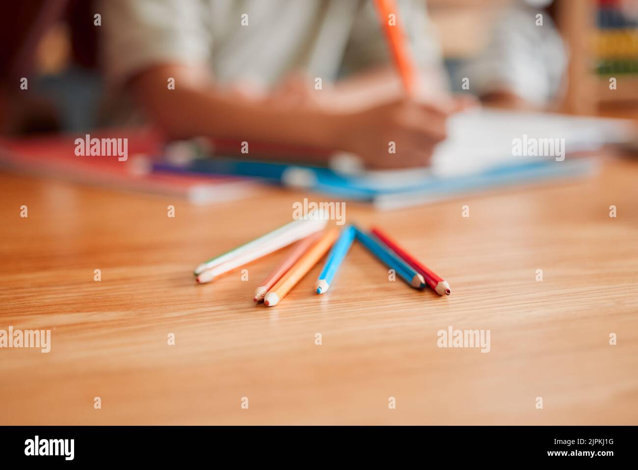 Pencils, crayons and pens on a table for creative drawing, artwork and ...
