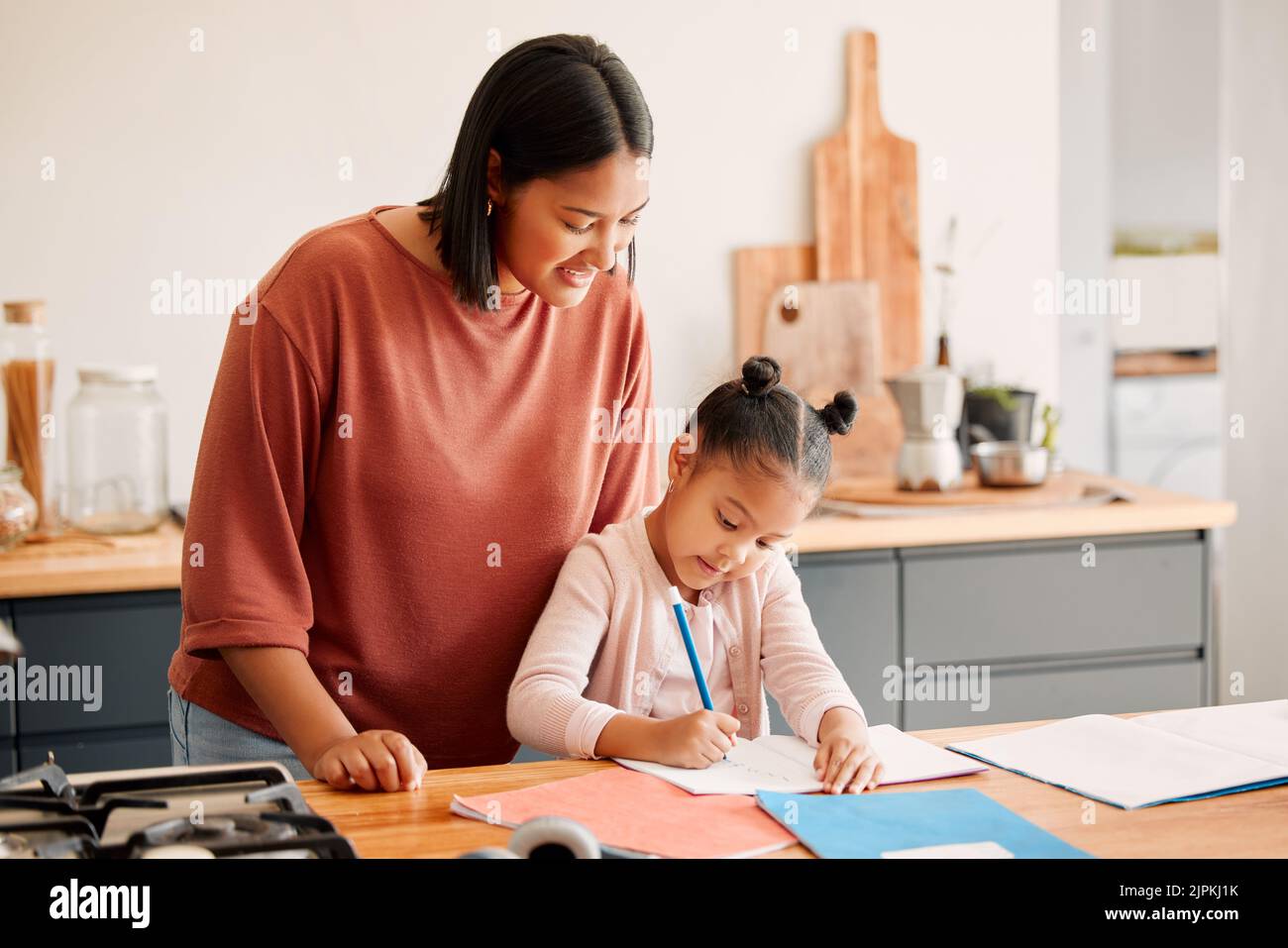 Home school, education and learning child while teaching mother watches ...