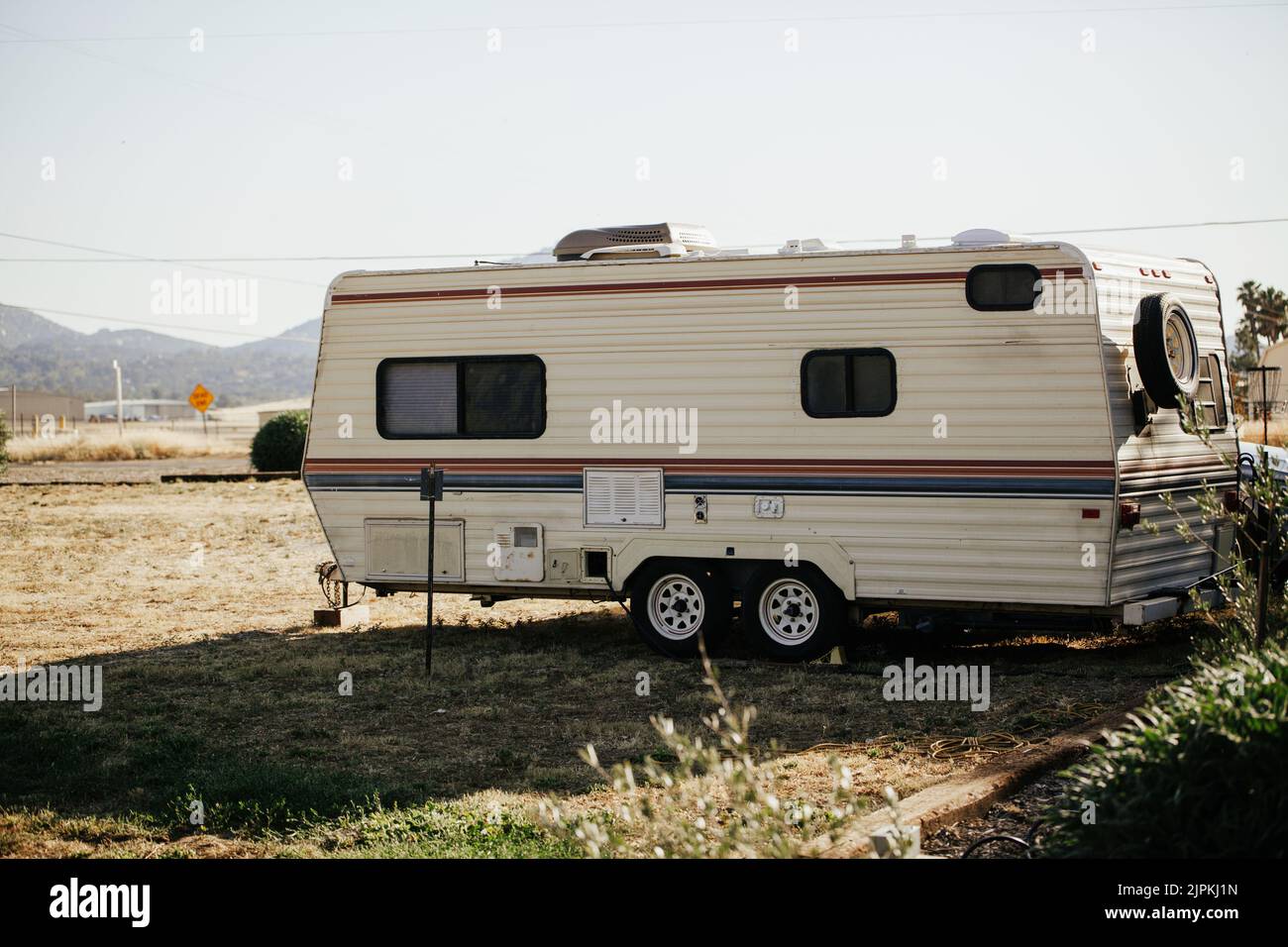 Old trailer parked on camping grounds Stock Photo - Alamy