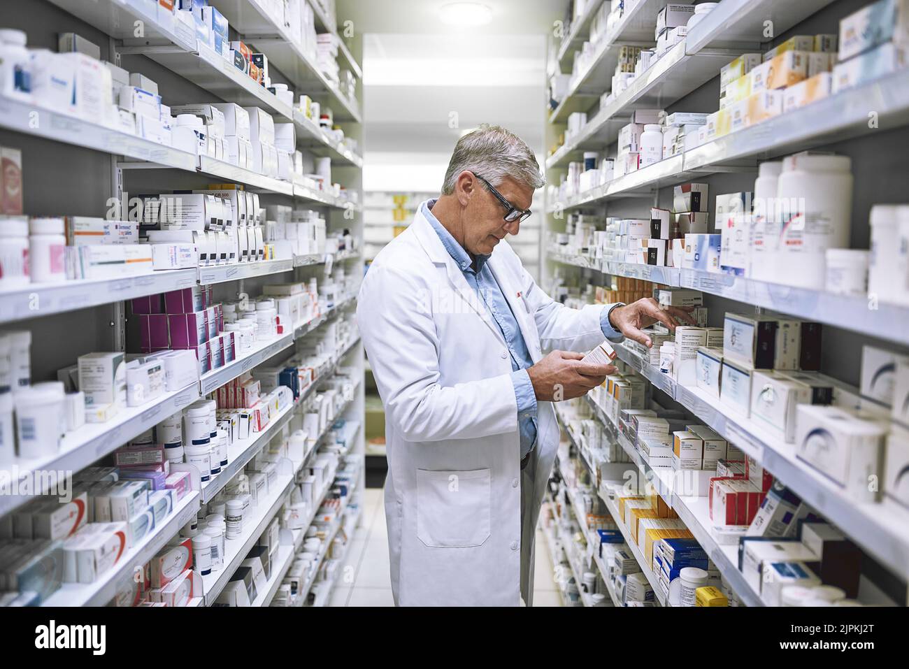 This stuff works wonders. a focused mature male pharmacist making notes ...