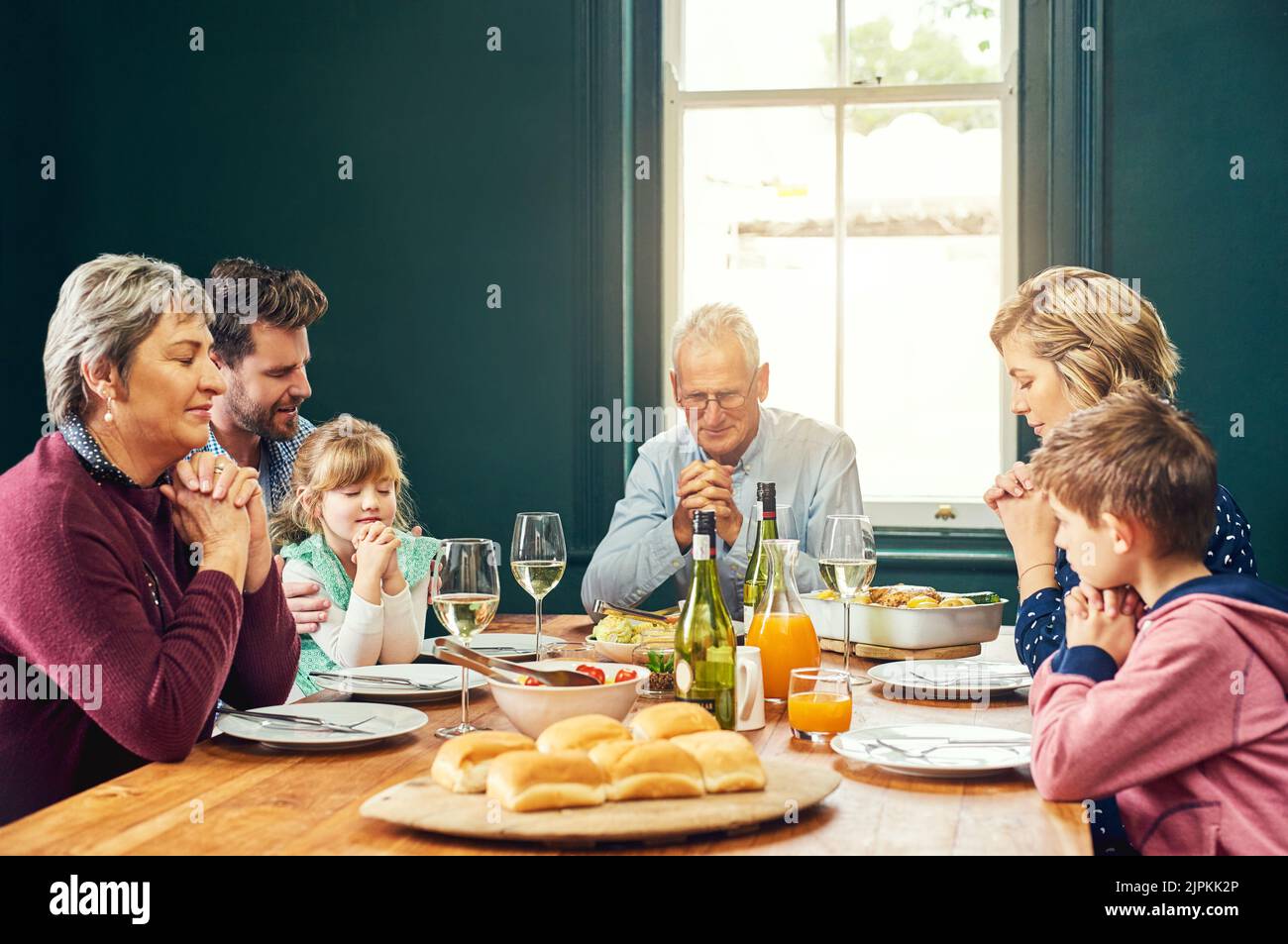 We are thankful to have each other. a peaceful family seated around the ...