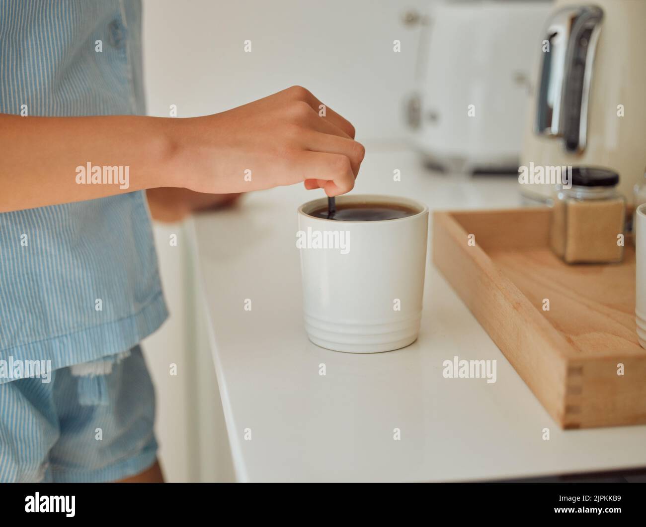 Making fresh, hot morning coffee indoors on a kitchen counter to start ...