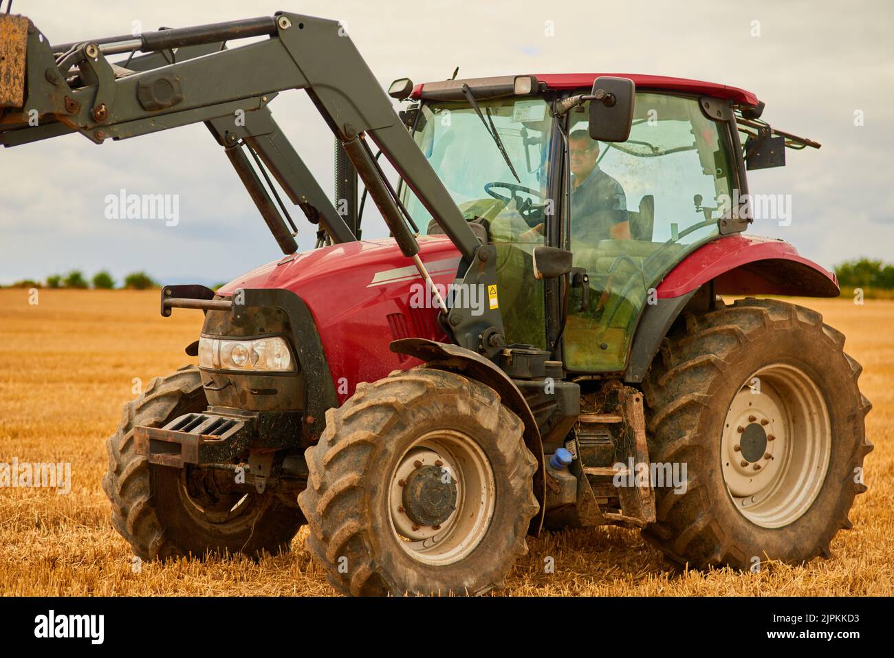 Every farm needs a tractor. a farmer driving a tractor around his farm ...