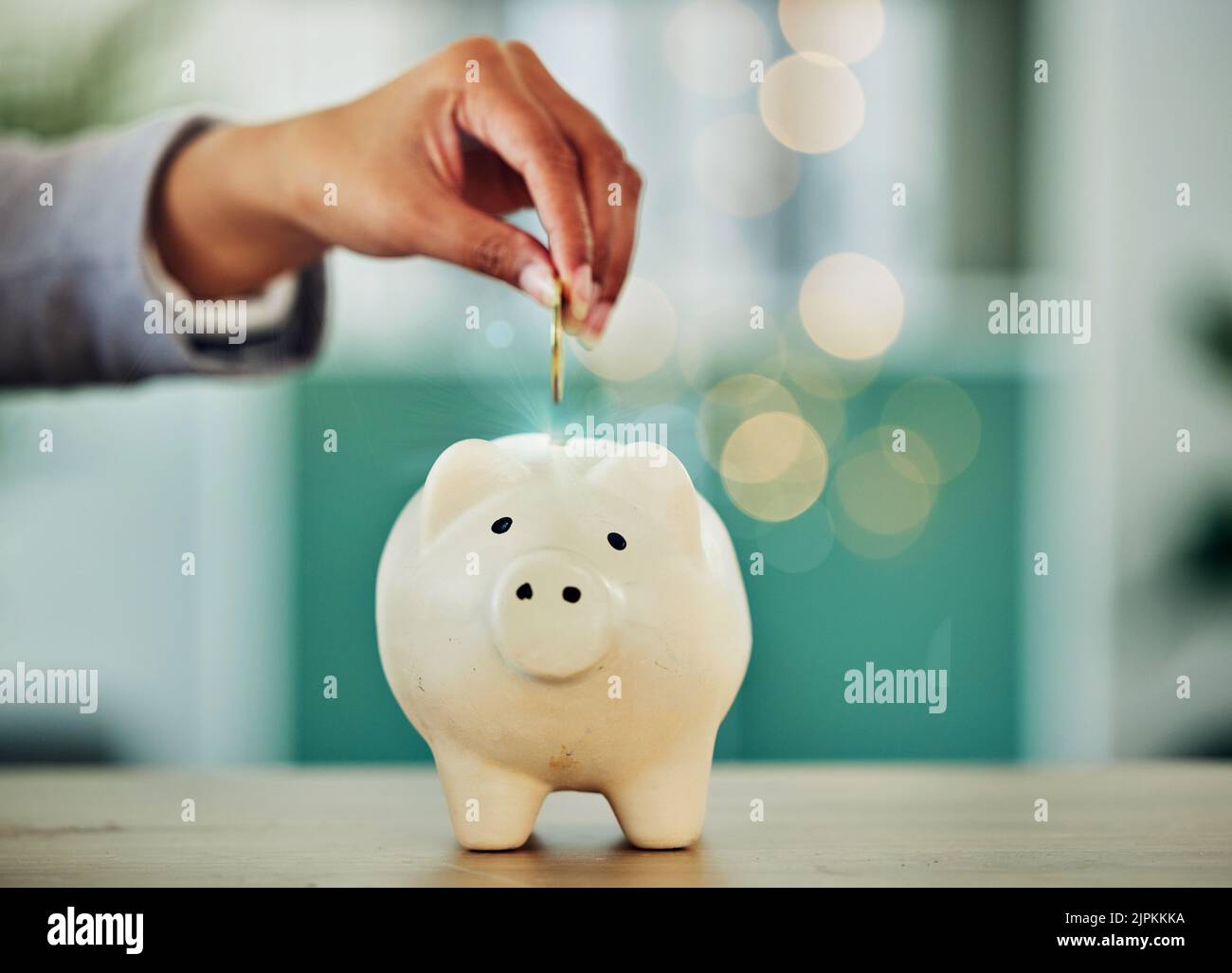 . Saving and investment for future, hand putting a coin into a piggy ...