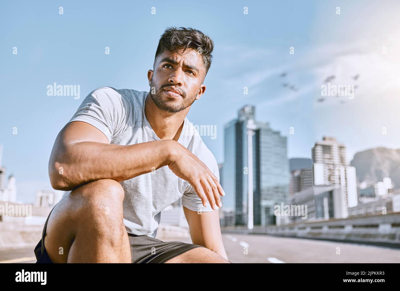 Exhausted, runner and fitness athlete taking a break after a morning ...