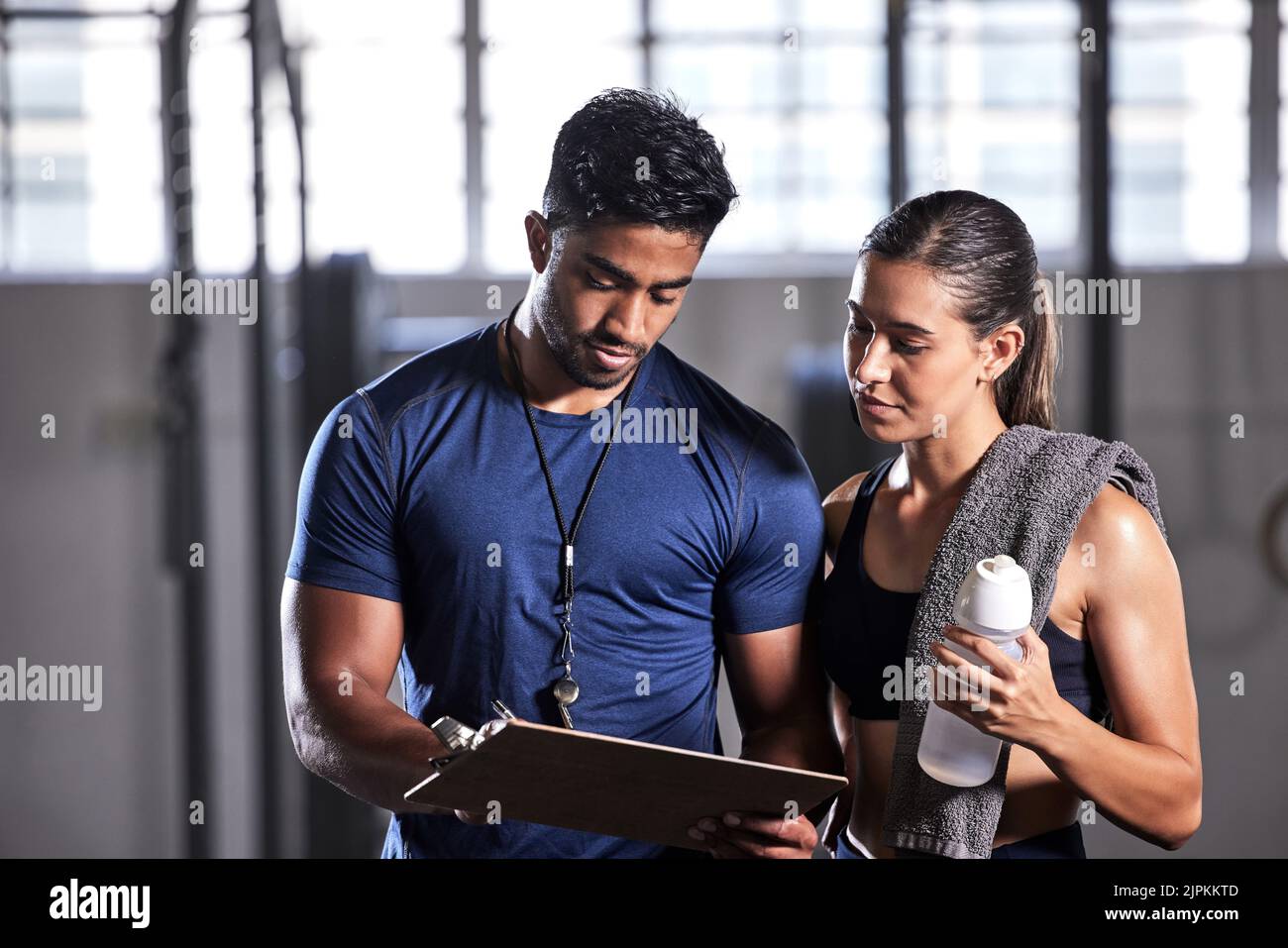 Coach planning workout, schedule and training with athlete for active ...