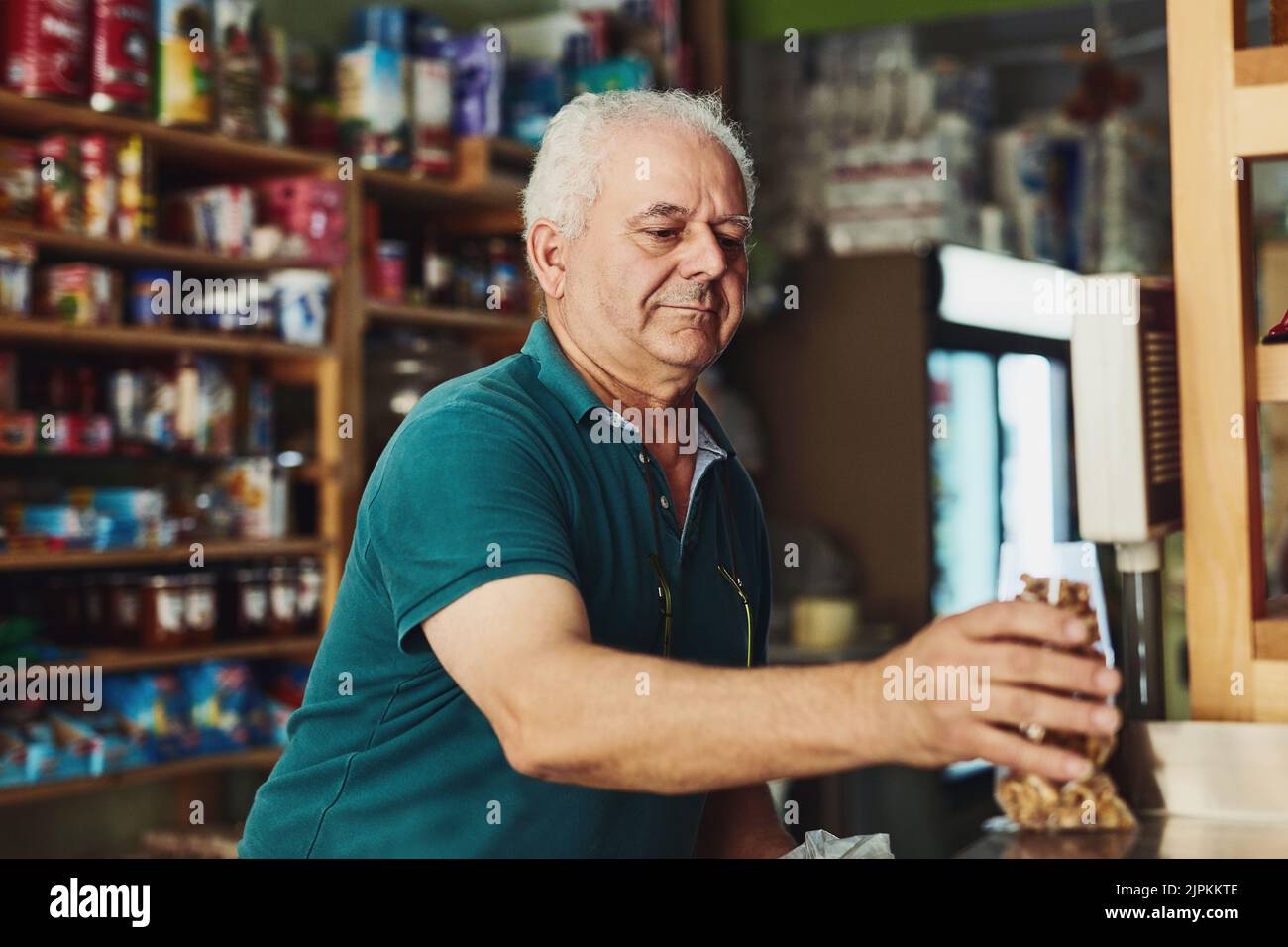 Old man working in a store hi-res stock photography and images - Alamy