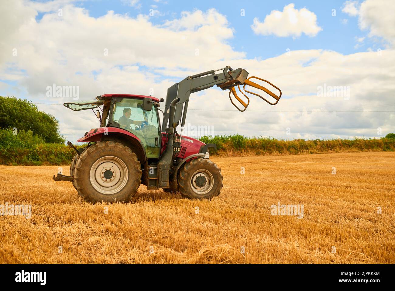 Now this is how you get around on a farm. a farmer driving a tractor ...