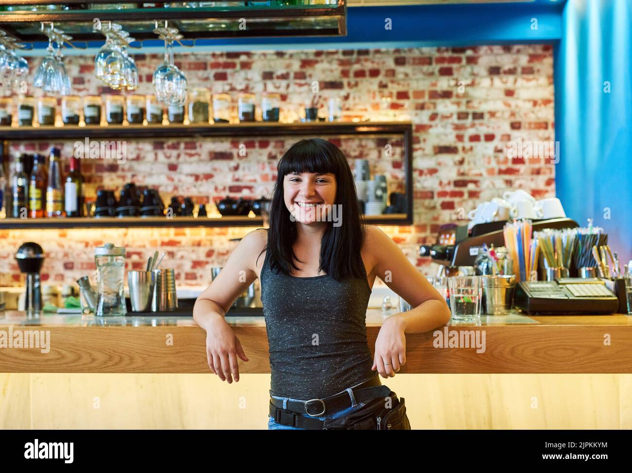 What she knows best. a waitress standing by the counter at a bar Stock ...