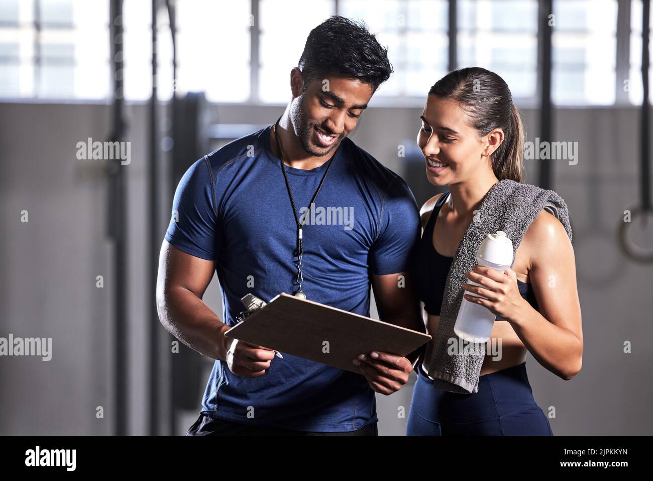 Gym subscription, personal trainer and happy client talking and ready to fill in a membership ...