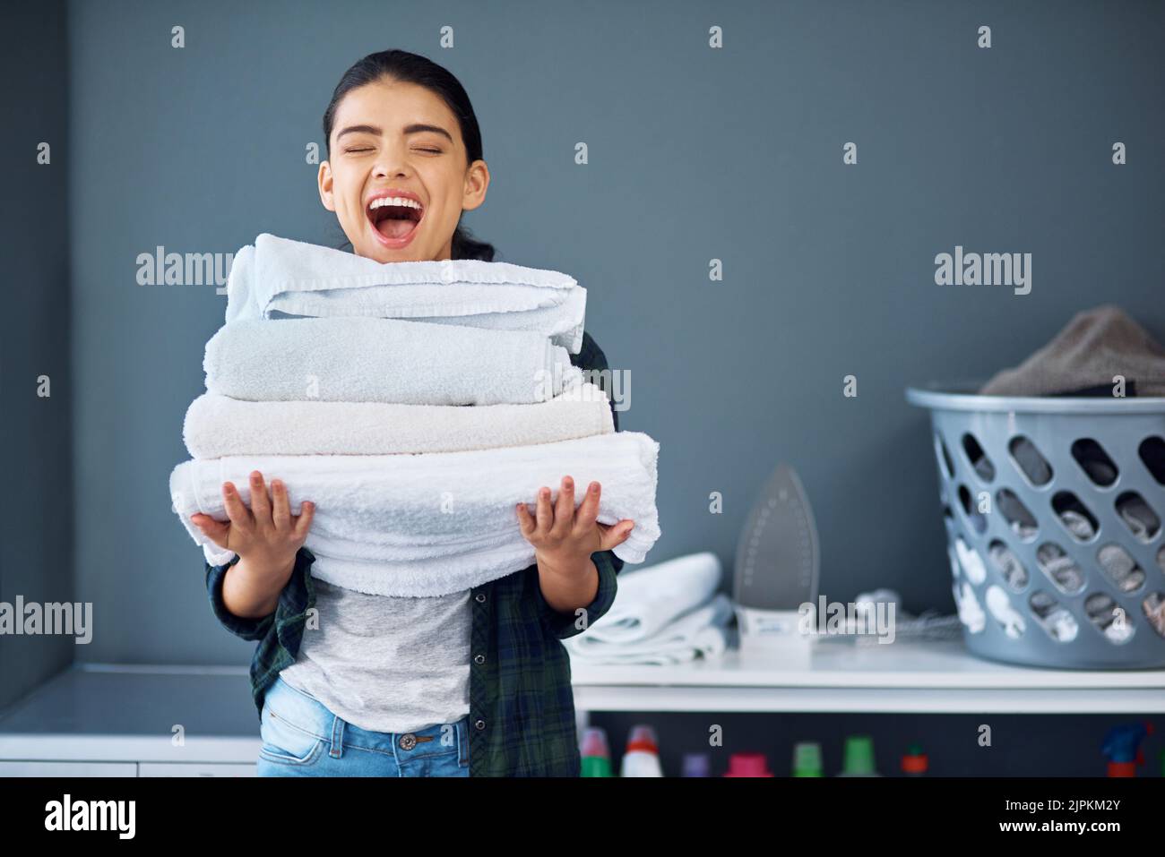 I love clean linen. an attractive young woman carrying a pile of towels ...