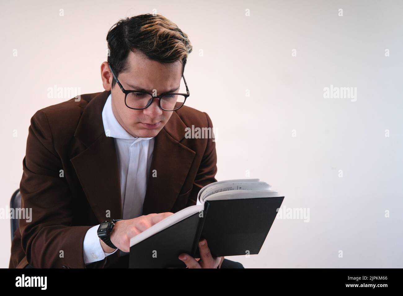 Smartly dressed studious man. Man dressed in brown jacket, white shirt ...