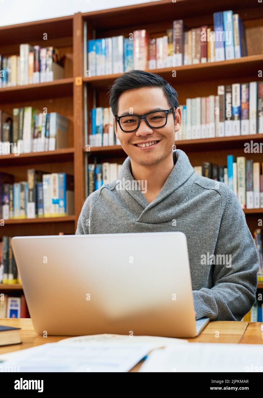 A man seated at a table with a laptop hi-res stock photography and ...